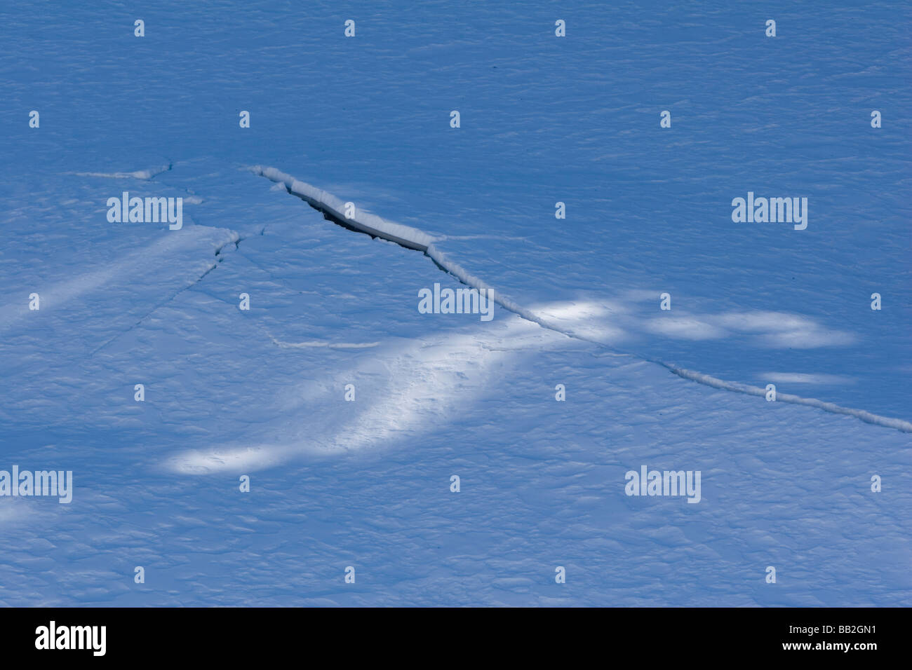 Ice on lake cracking as water levels reduce Stock Photo - Alamy