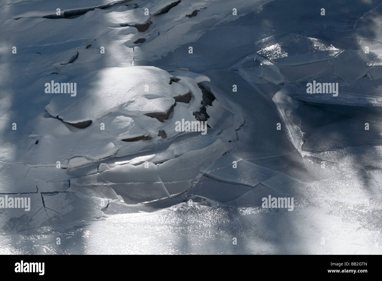 Ice on lake cracking as water levels reduce Stock Photo - Alamy