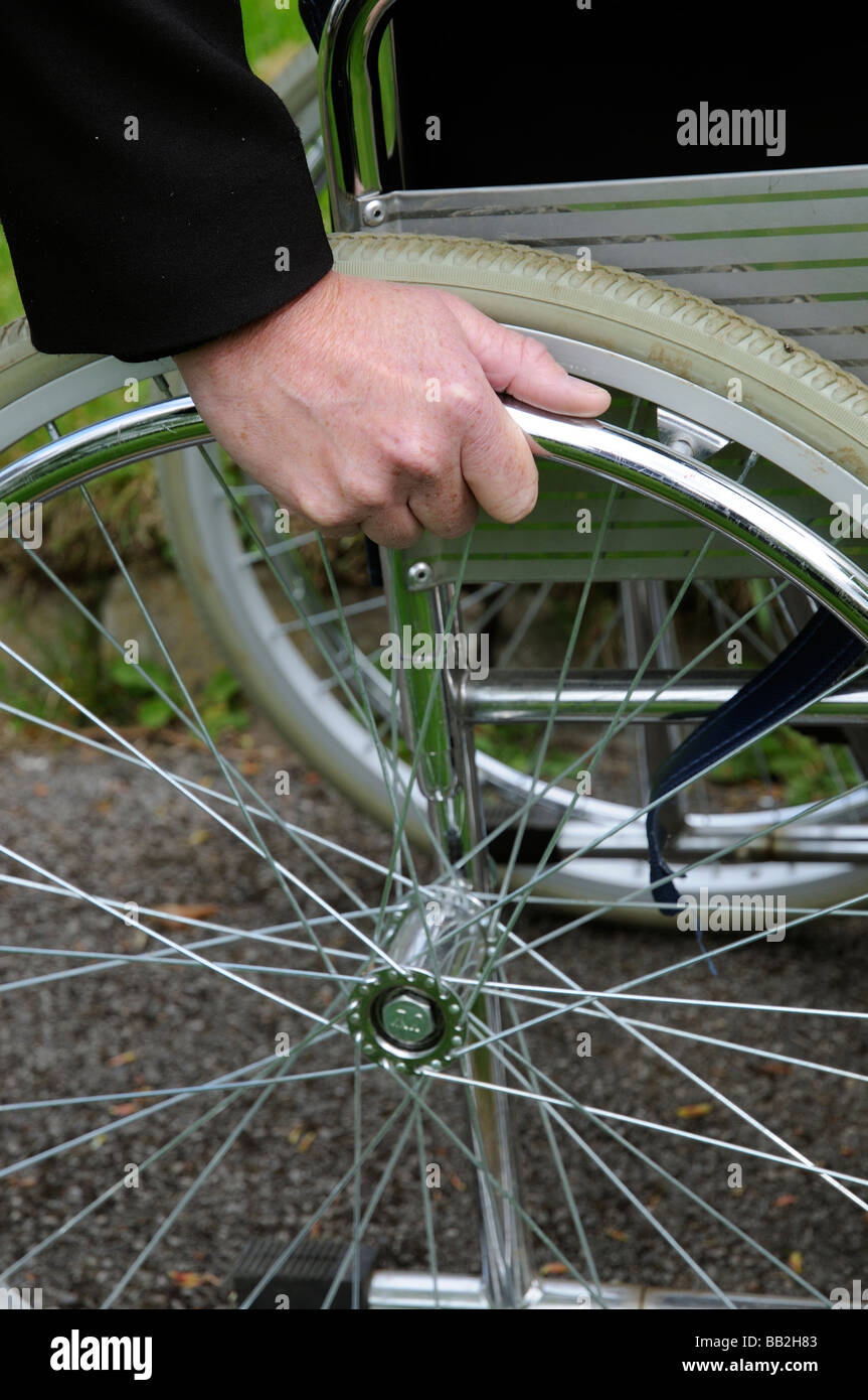 Womans hand pushing wheelchair wheel Stock Photo - Alamy Womans hand pushing wheelchair wheel Stock Photo - Alamy
