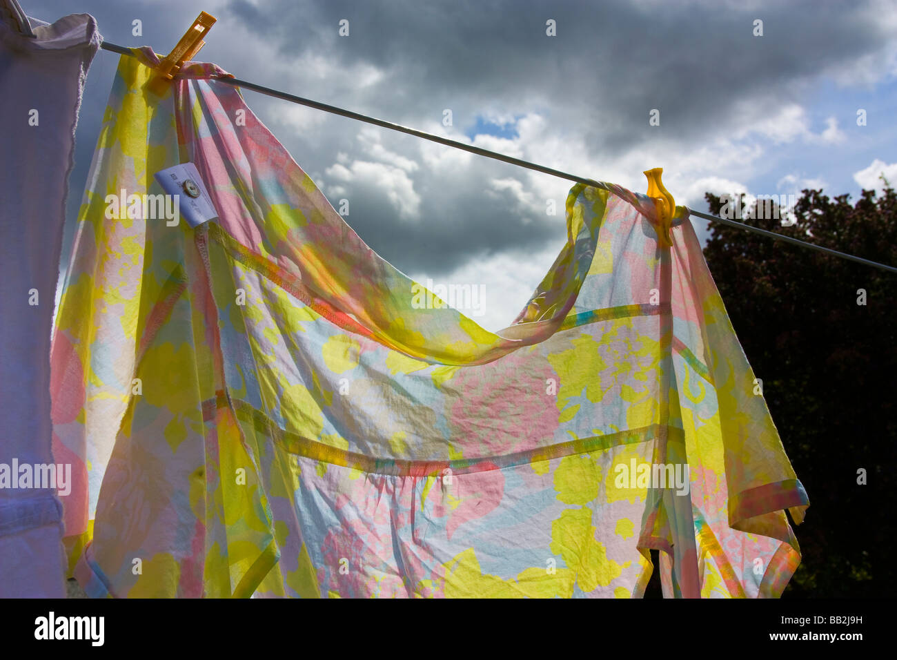 Washing hanging on line in sun with moody sky and clouds Stock Photo ...