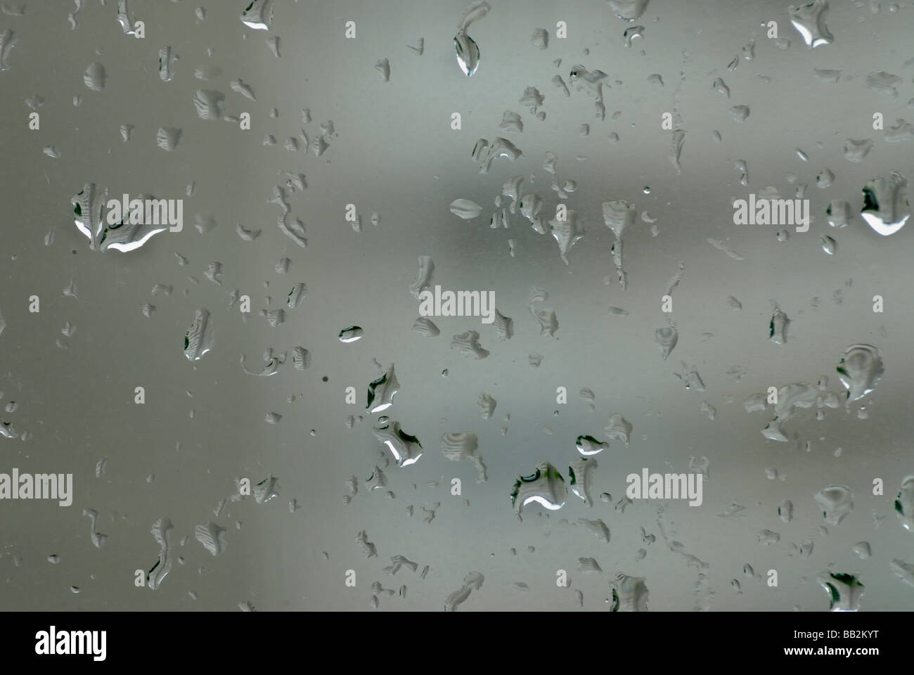 Rain drops with reflections of building on the glass window Stock Photo ...