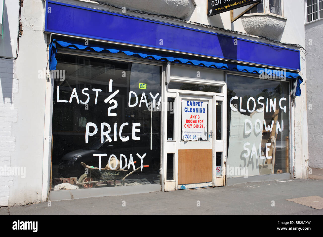 A Closed Down Shop with closing down sign painted inside its front ...