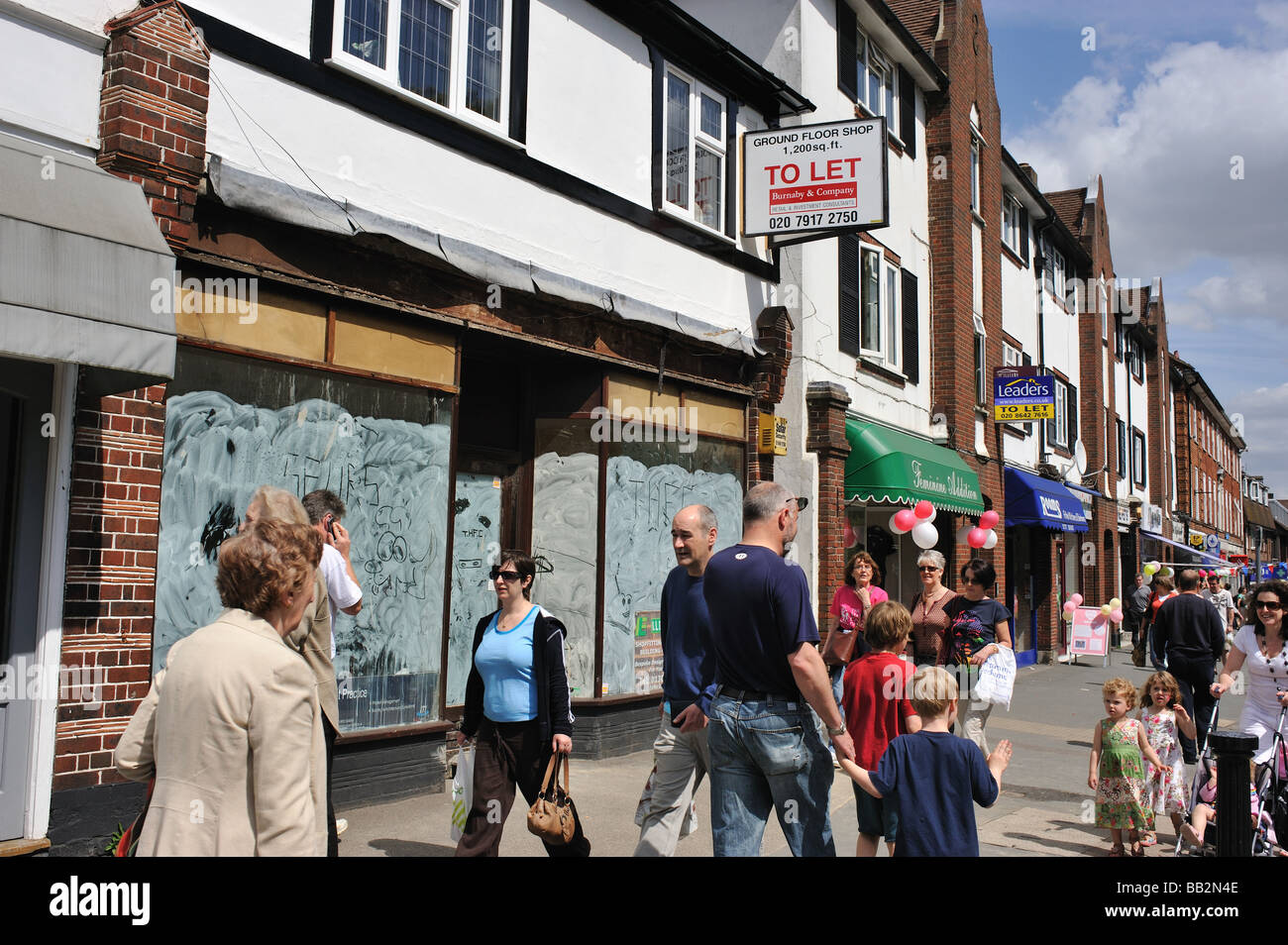A Closed Down Shop with people walking past its shop front in Banstead ...