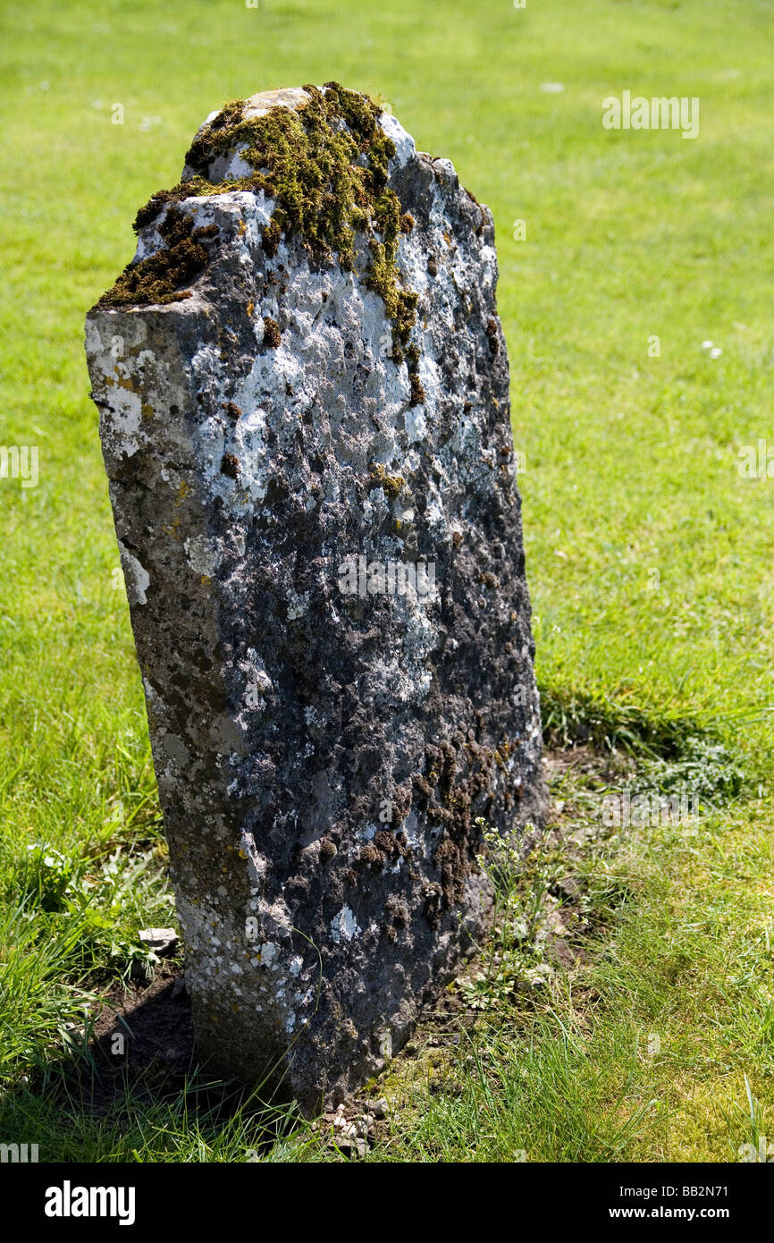 Old stone covered with moss in a graveyard in a cemetery in Western ...