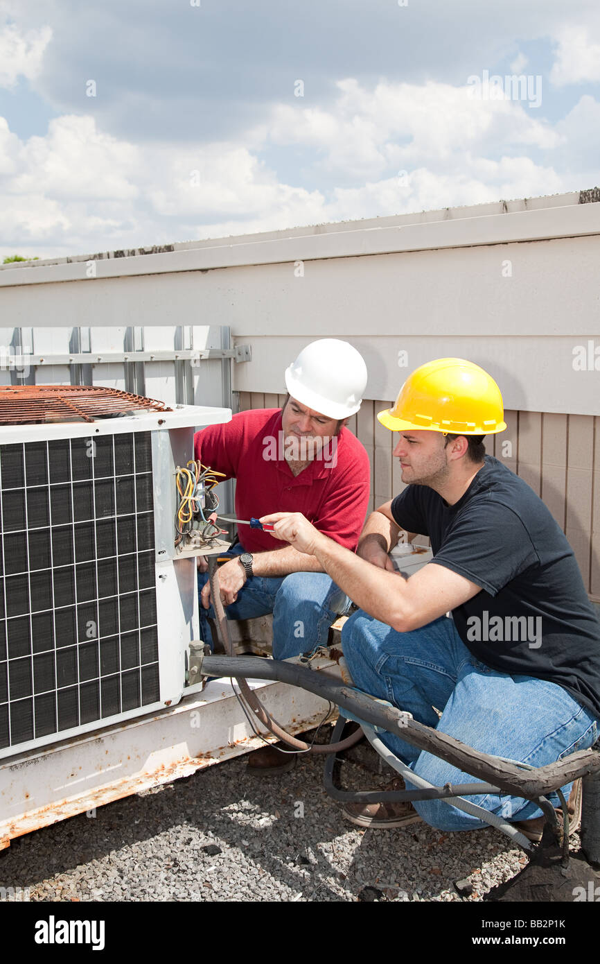 Instructor trains student to repair air conditioning compressor Stock ...