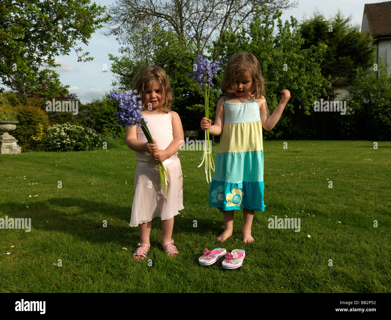 Sisters with Bluebells May Bank Holiday Stock Photo - Alamy