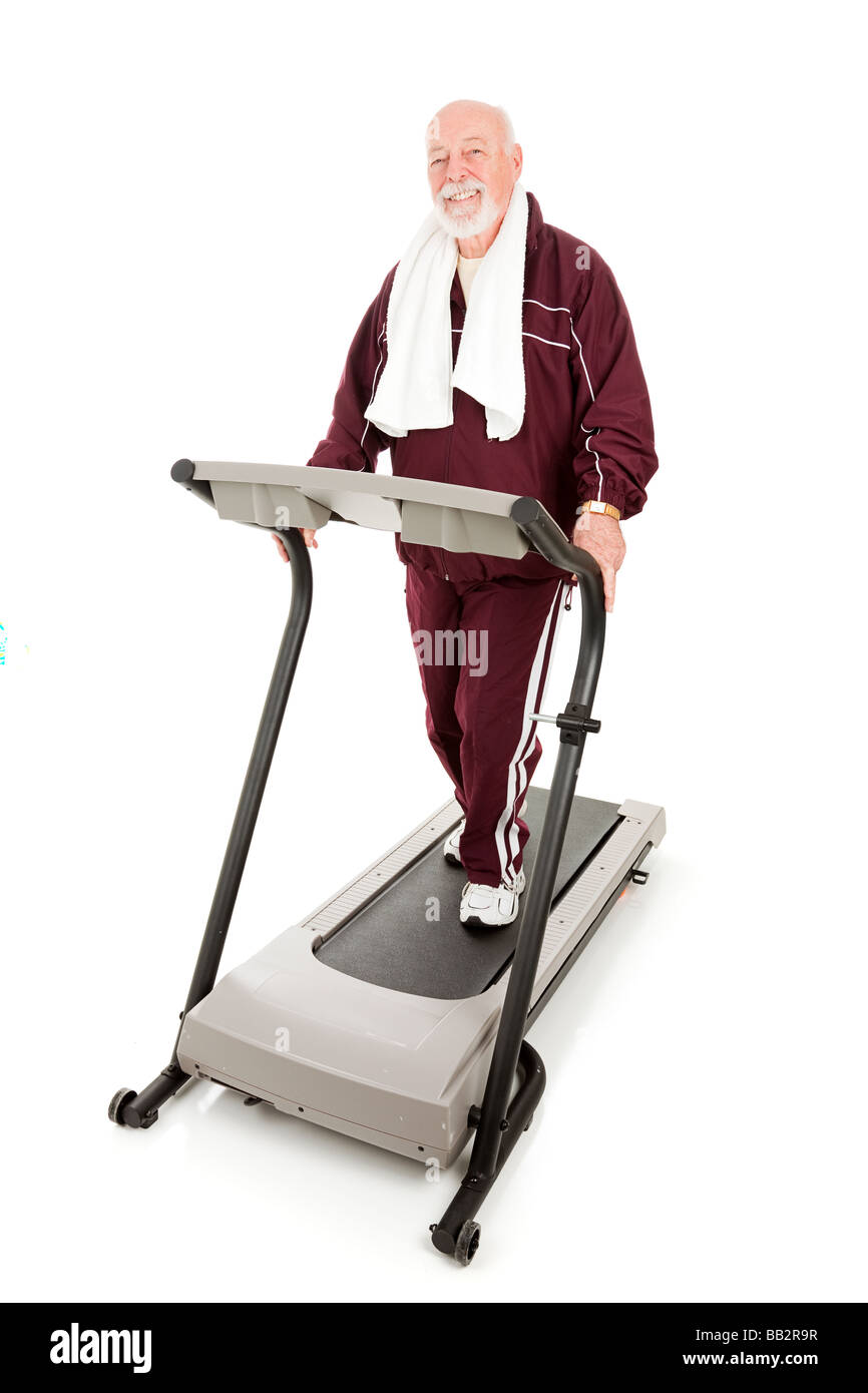 Handsome fit senior man exercising on a treadmill Full body isolated ...