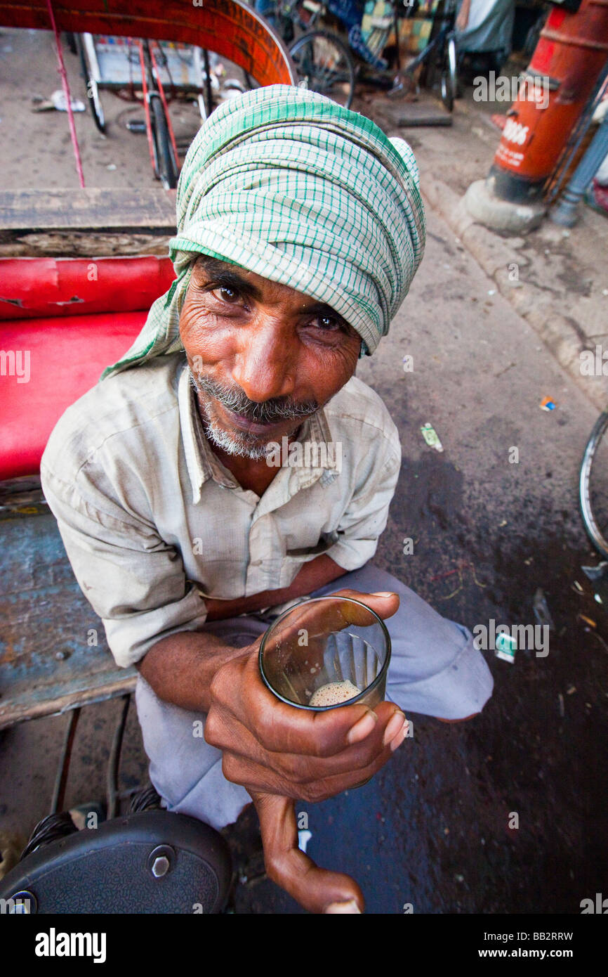 Bicycle Rickshaw Driver Drinking Tea in Old Delhi India Stock Photo - Alamy