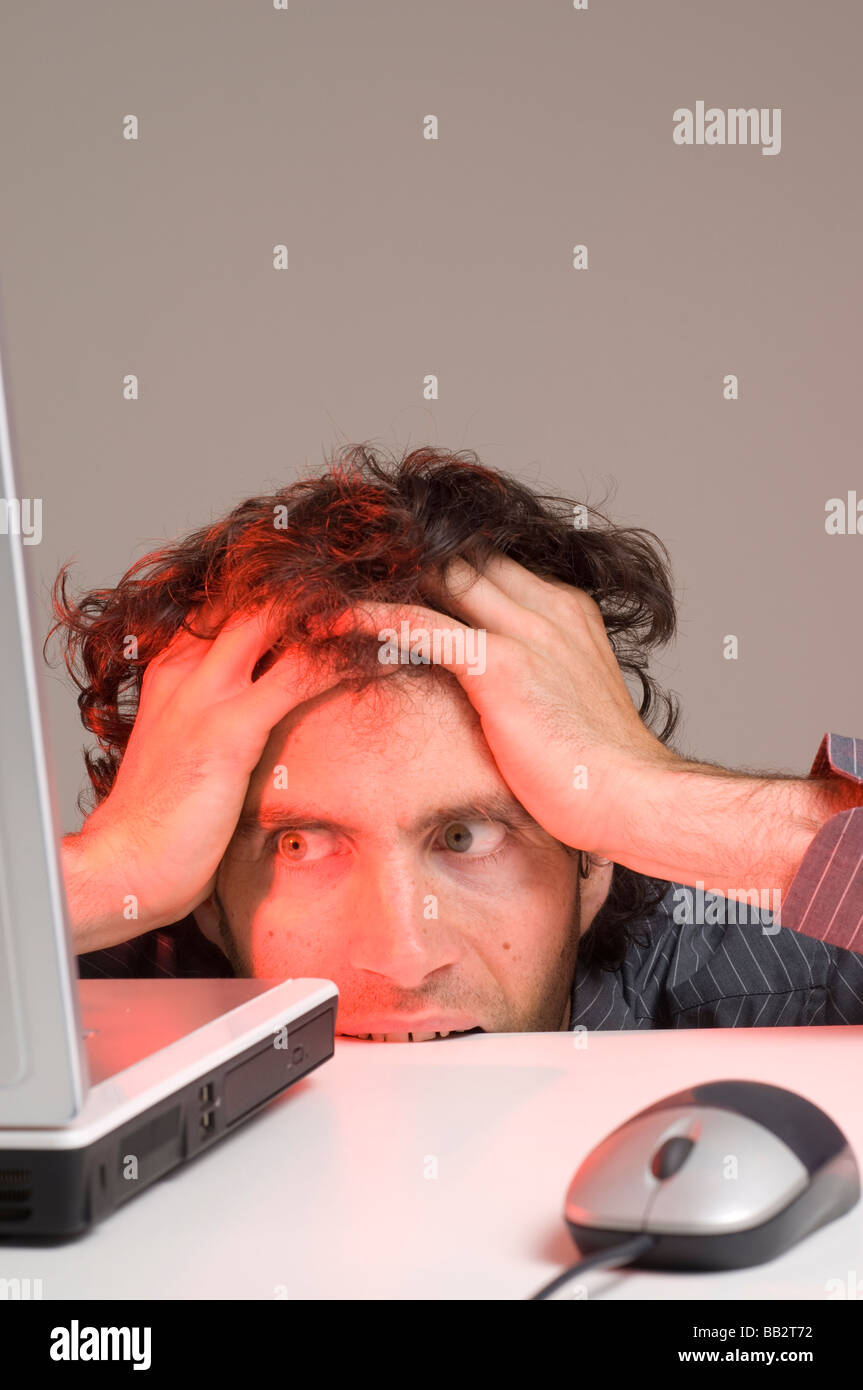 Man pulling out hair while looking at computer screen Stock Photo - Alamy