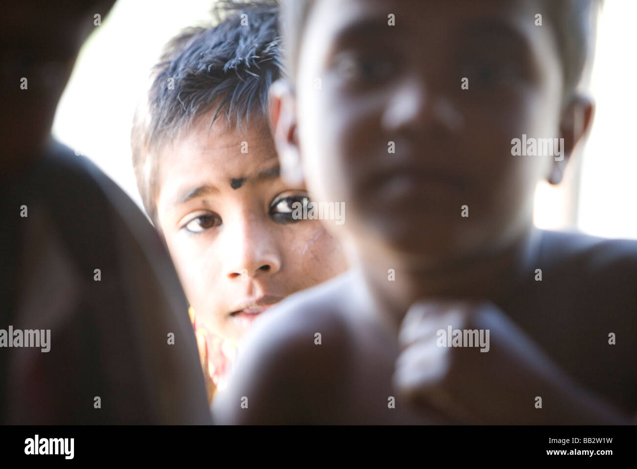 Daily Life in Bangladesh; A boy peeks out among his friends Stock Photo ...