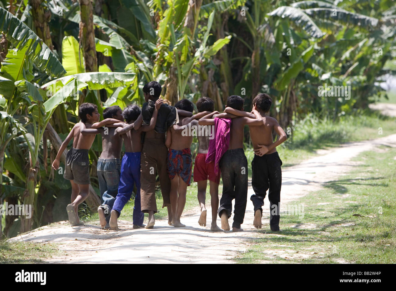 Daily Life in Bangladesh; Boy walk with their arms around each others ...