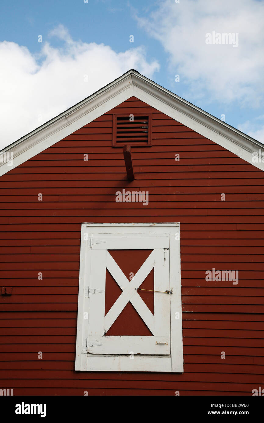 Photo of a portion of a red and white barn with blue sky and clouds in ...