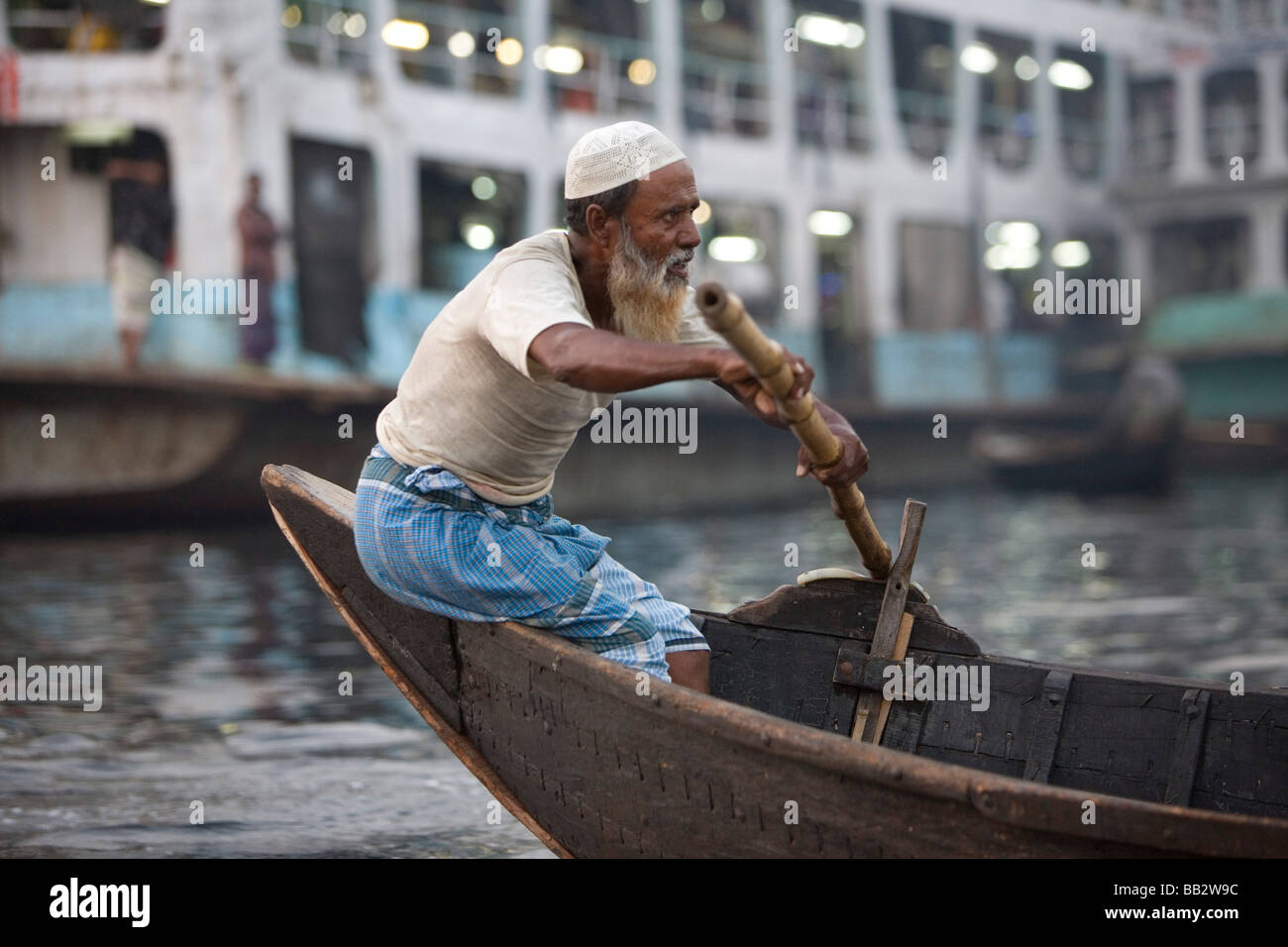 Daily Life in Bangladesh; A man pilots his row boat in Dhaka's busy ...