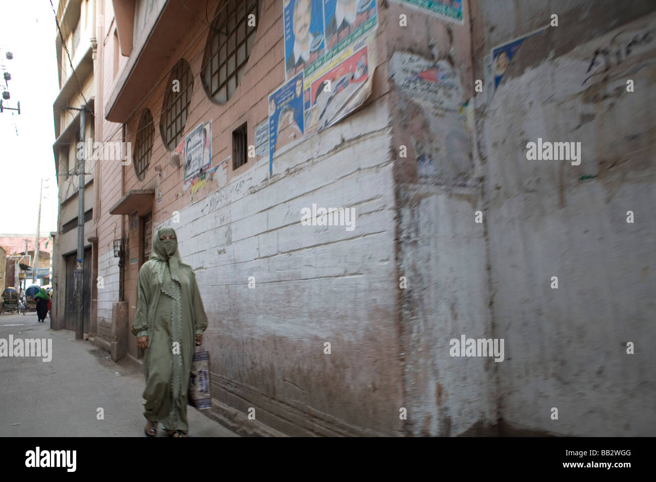 Daily Life in Bangladesh; a woman wearing traditional burka walks the ...