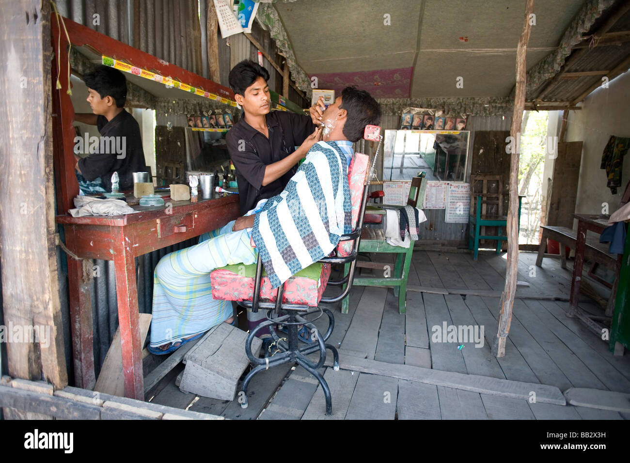 Daily Life in Bangladesh; a man gets a shave from the local barber ...