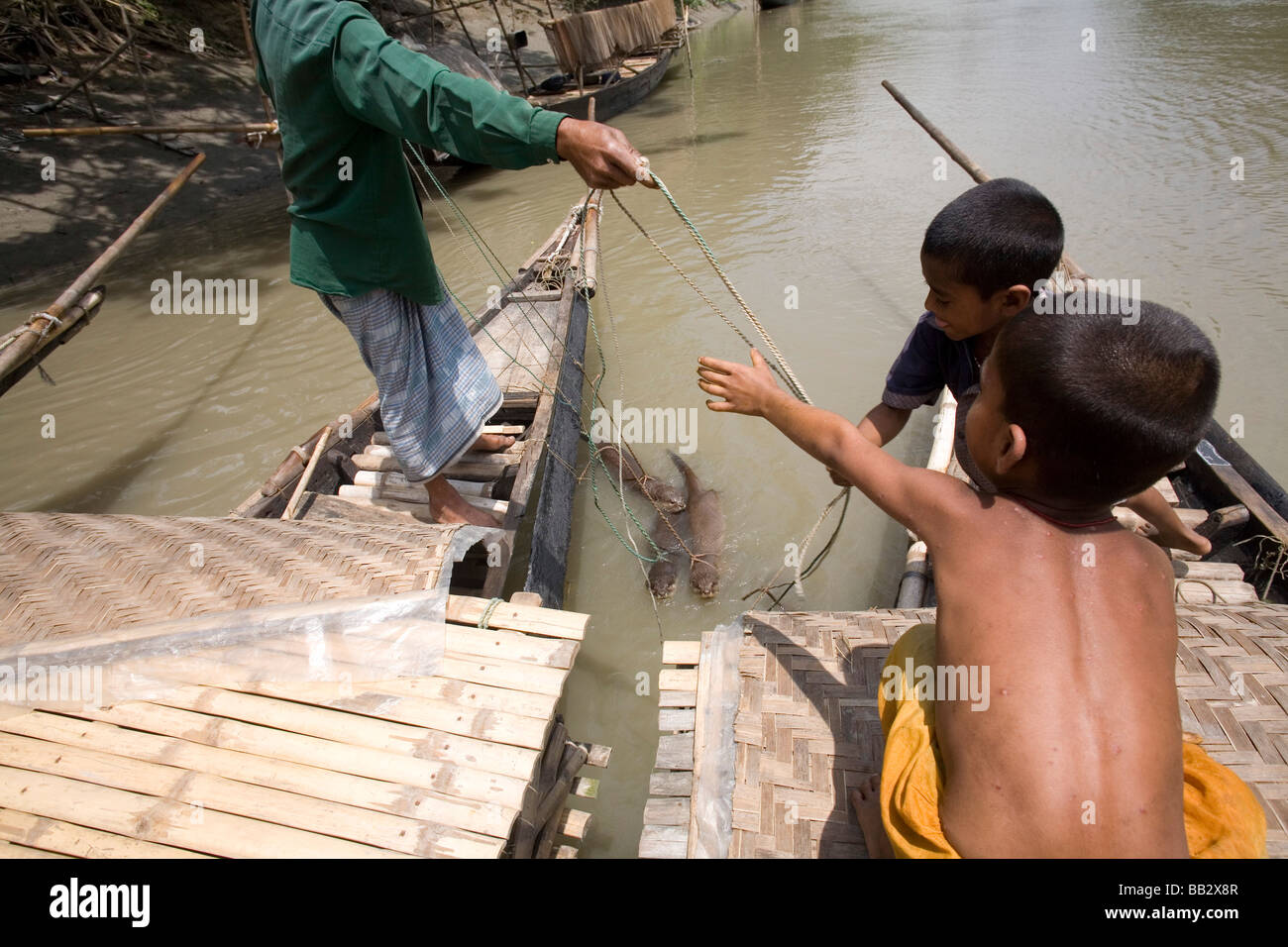 Daily Life in Bangladesh; a man hands off a leash of his trained ...