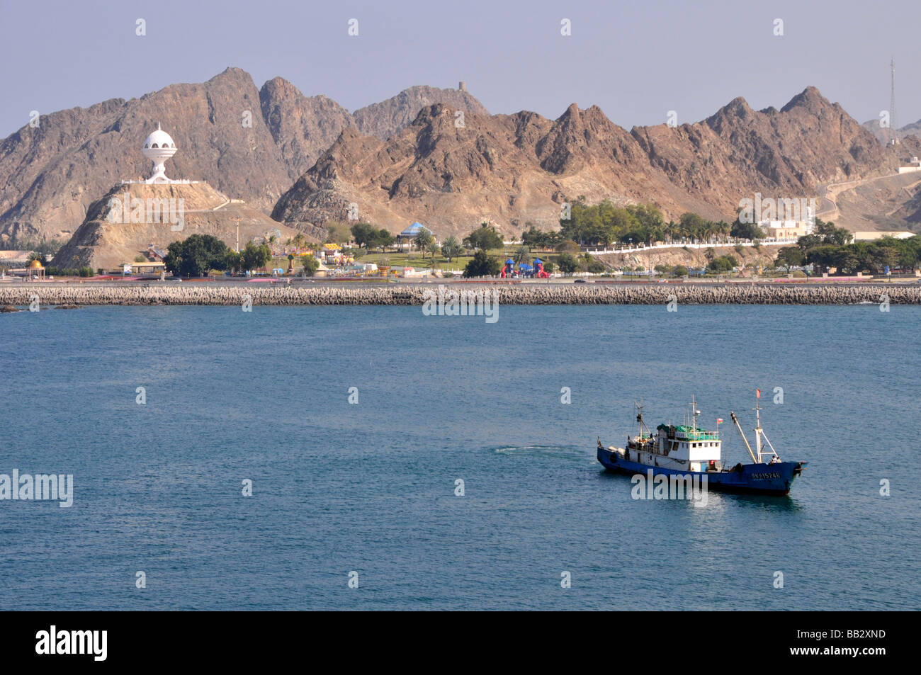 Muscat Oman waterfront with rocky coastline and incense burner watch ...