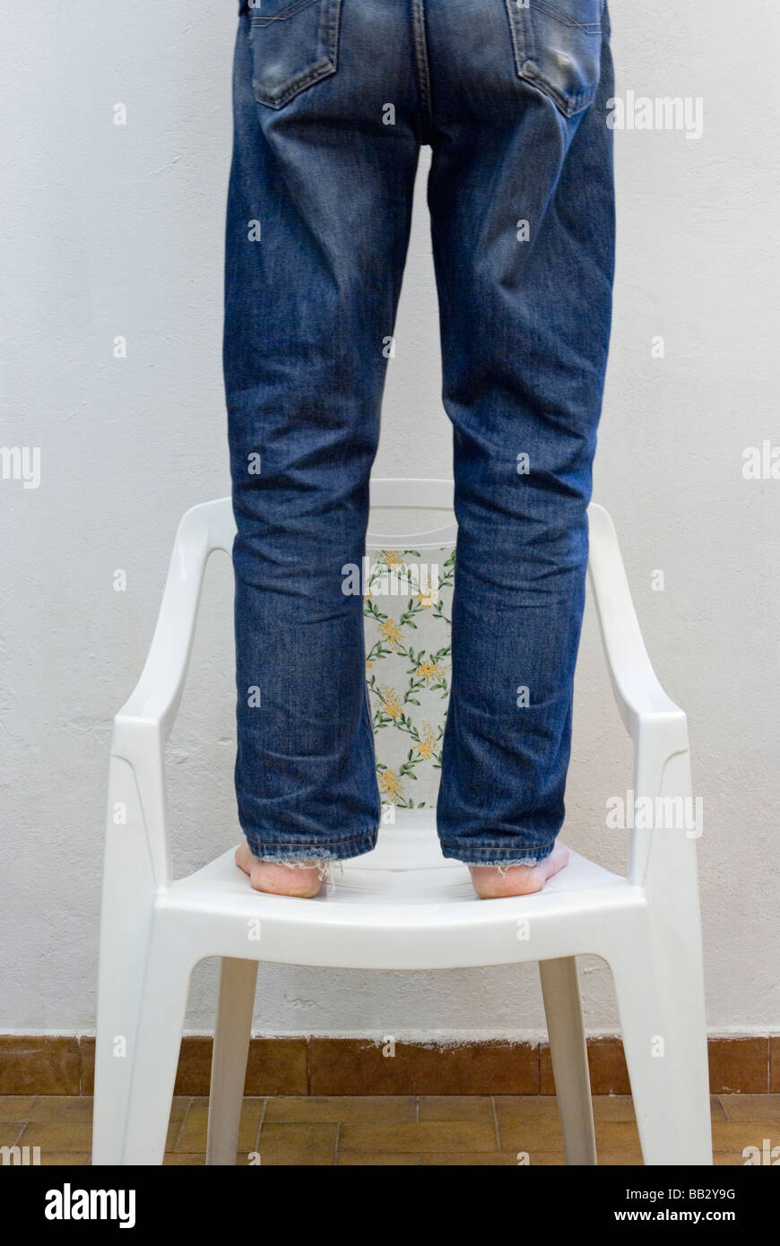 Man standing feet on chair hi-res stock photography and images - Alamy