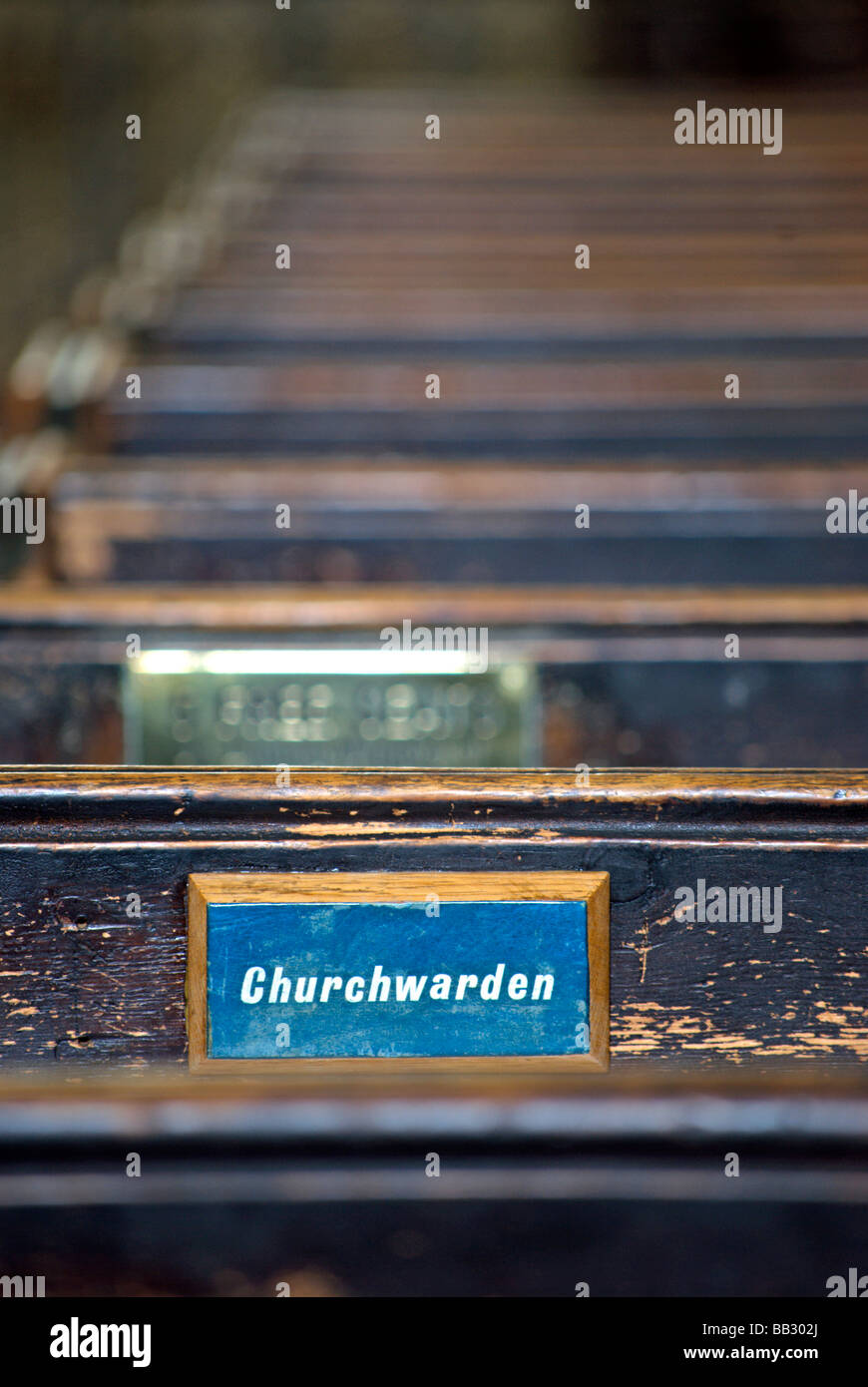sign on back of british church pew showing space reserved for ...