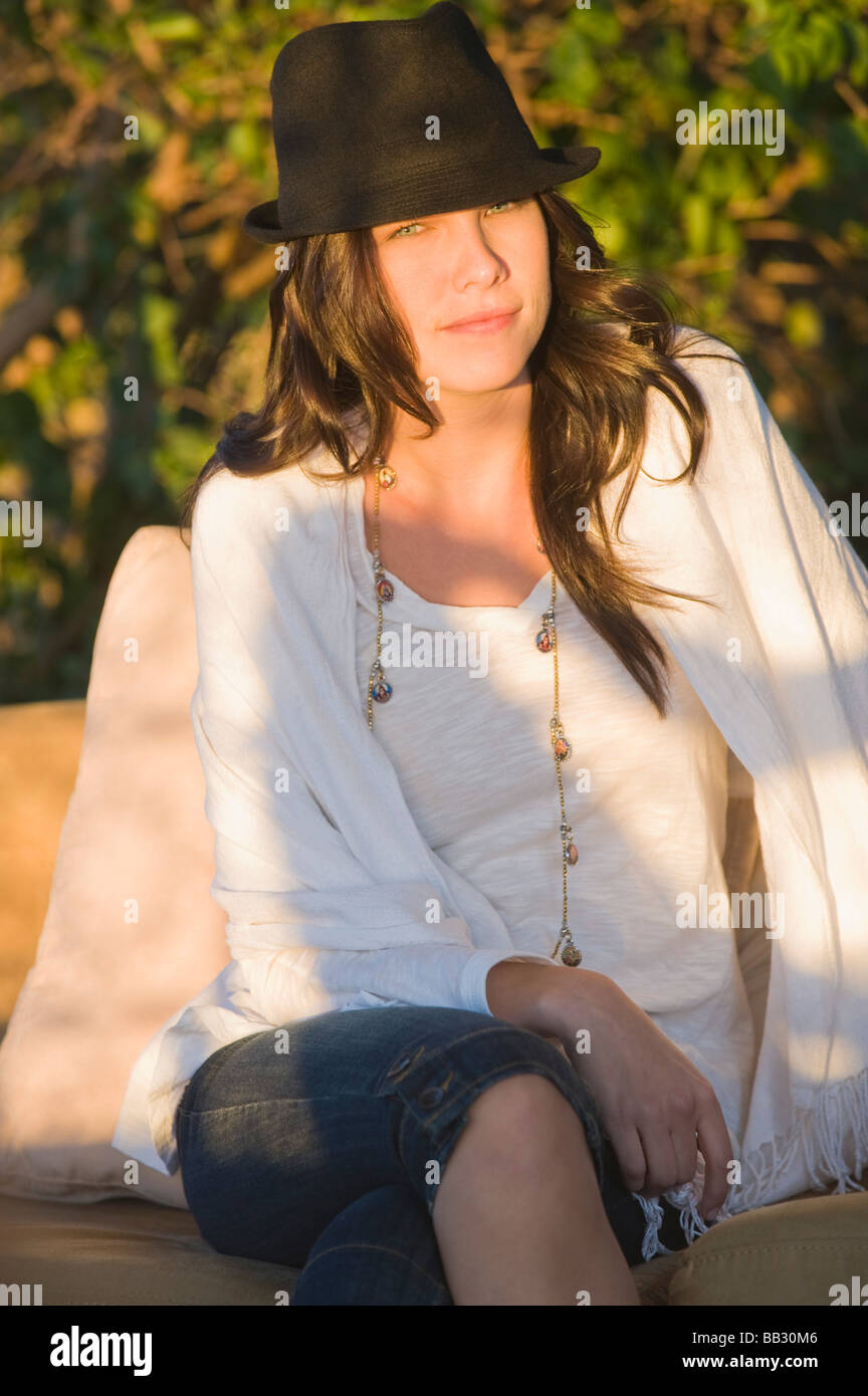 Portrait of a woman sitting on a couch Stock Photo - Alamy