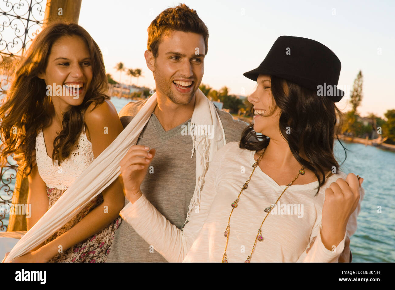 Three friends smiling Stock Photo - Alamy