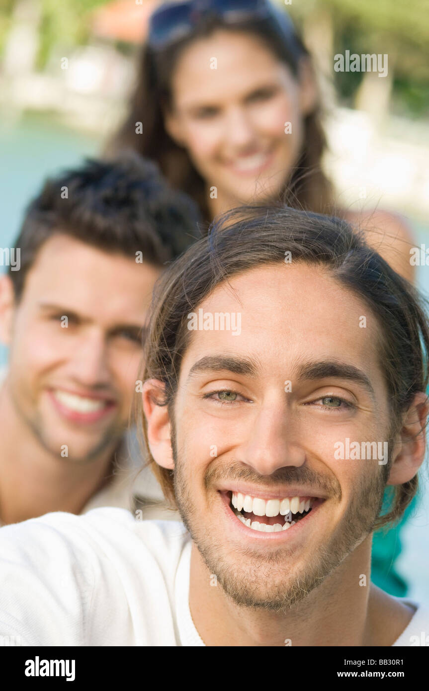 Three friends smiling Stock Photo - Alamy