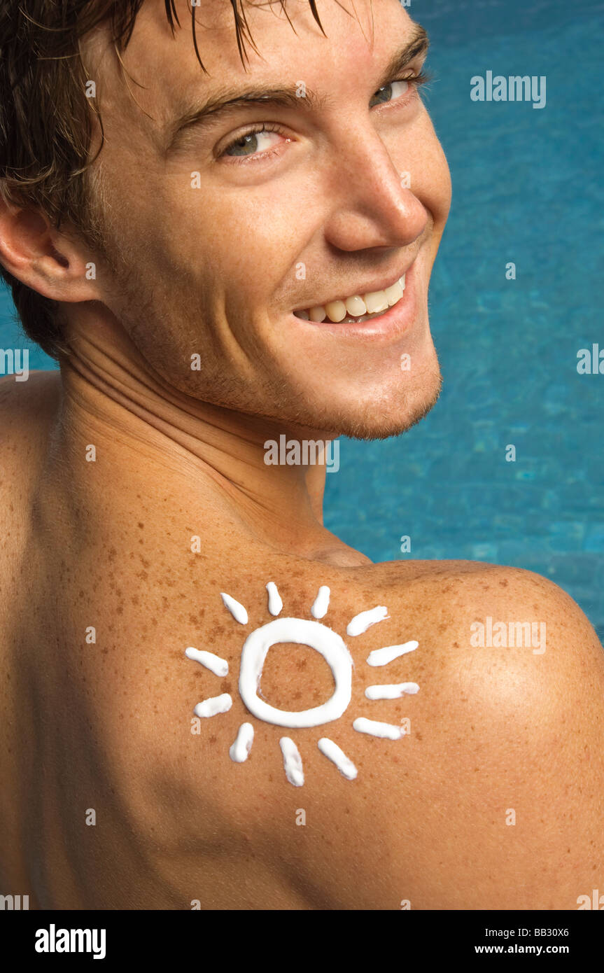 Man with sun shape on his shoulder at the poolside Stock Photo - Alamy