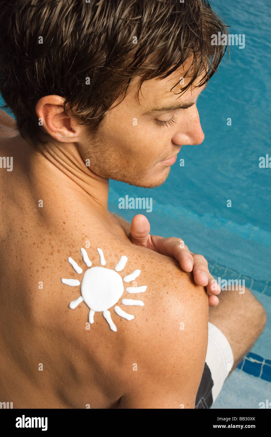 Man with sun shape on his shoulder at the poolside Stock Photo - Alamy