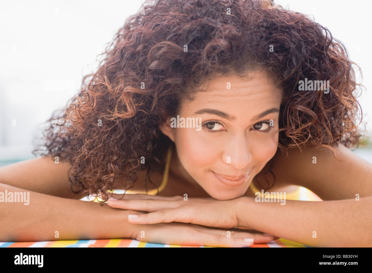 Woman sunbathing at the poolside Stock Photo - Alamy