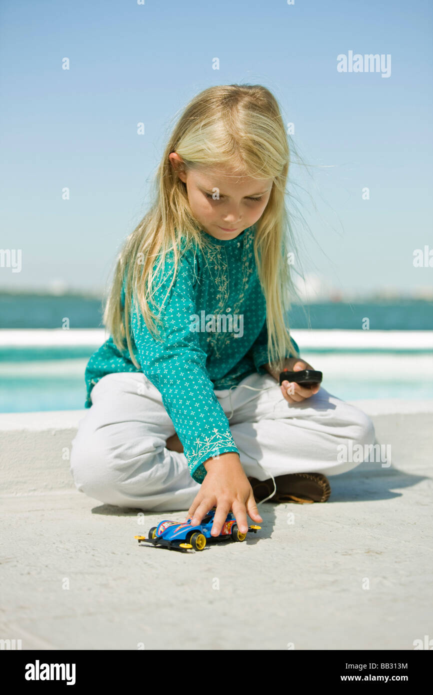 Girl playing with a remote controlled car Stock Photo - Alamy