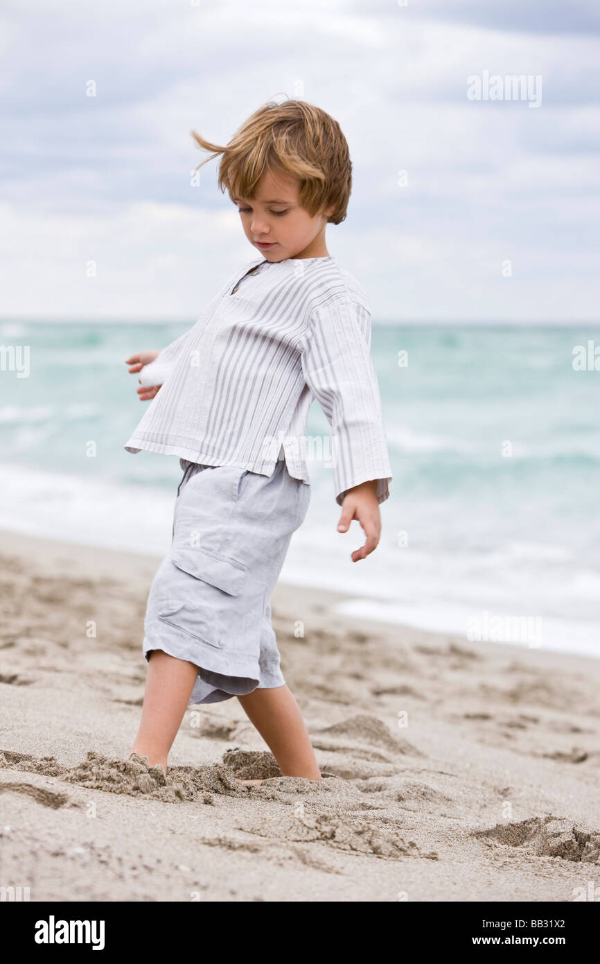 Boy playing on the beach Stock Photo - Alamy
