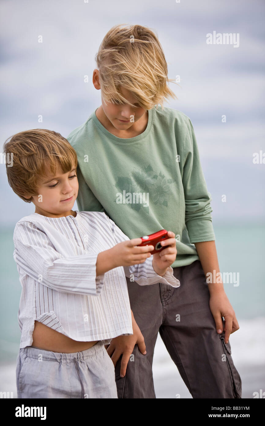 Two boys looking at a camera Stock Photo - Alamy