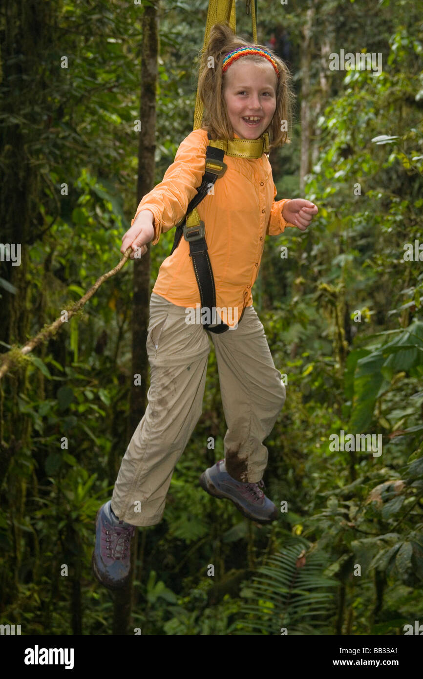 Girl on zip line cable ride over cloudforest, Sachatamia Lodge, Mindo ...