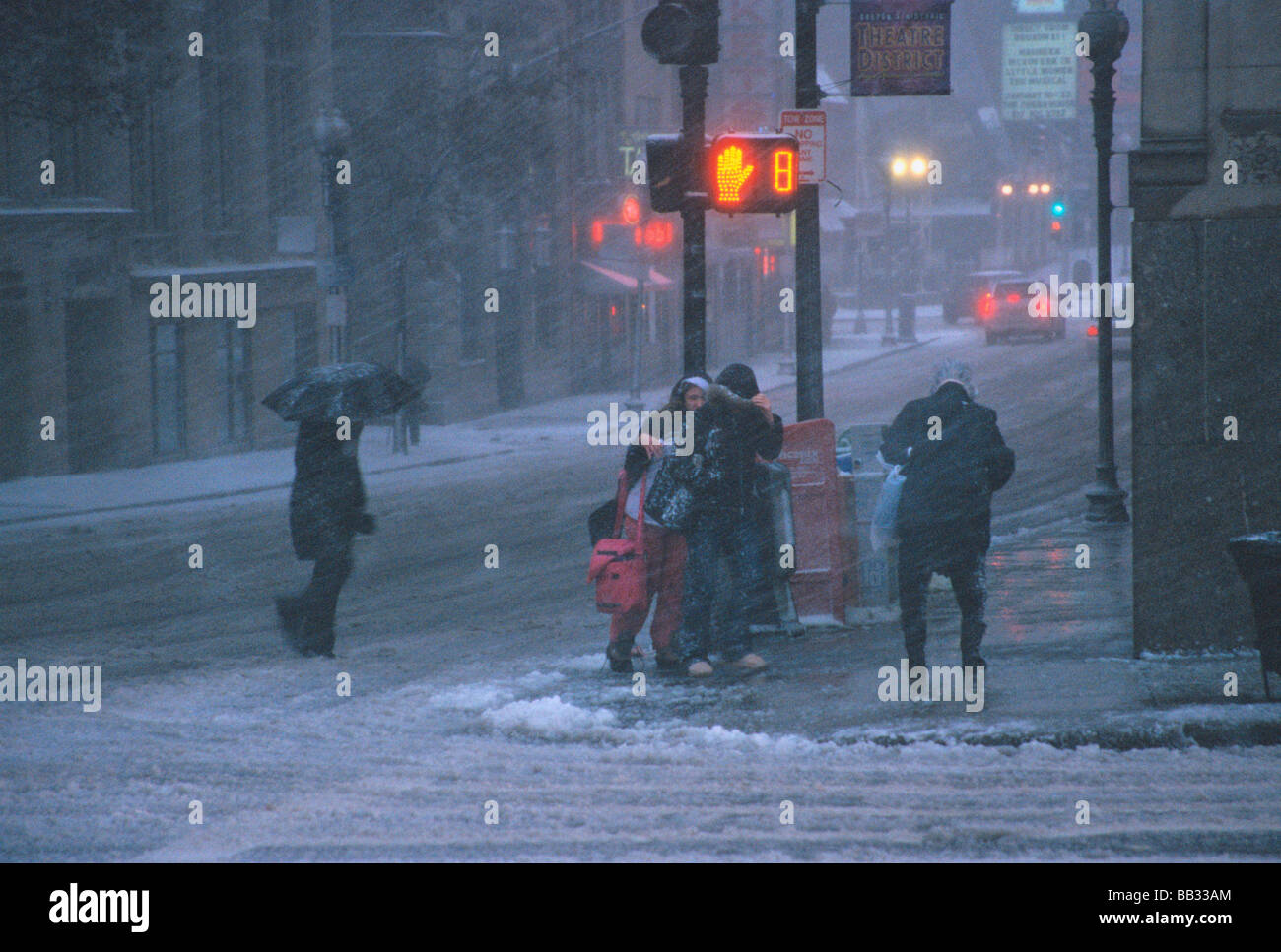 People struggle against the snow and wind in a severe thundersnow ...
