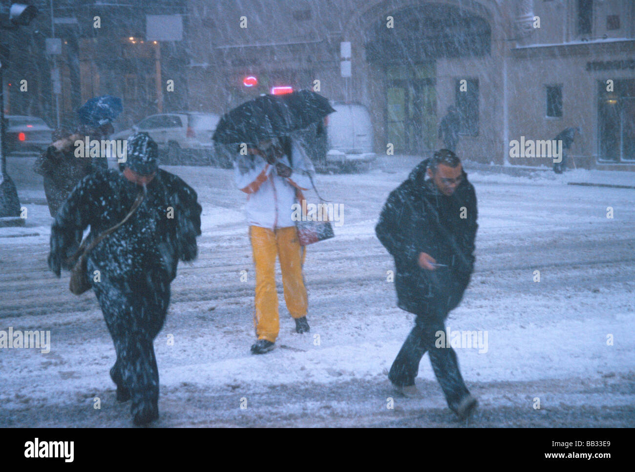 People struggle against the snow and wind in a severe thundersnow ...