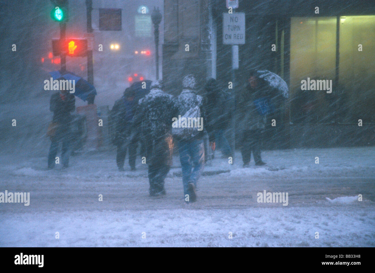 People struggle against the snow and wind in a severe thundersnow ...