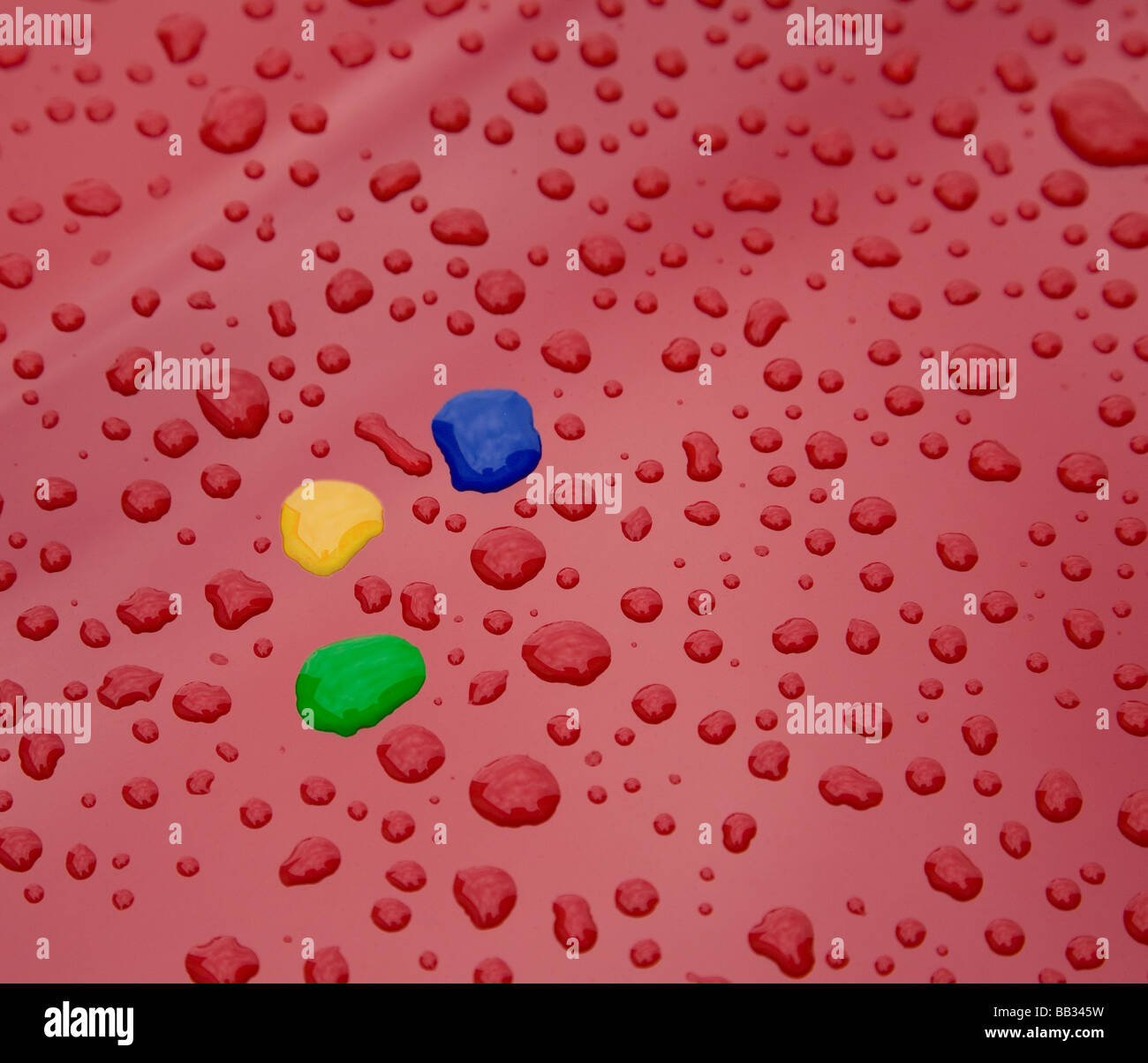 Coloured and clear water droplets on a glossy red painted surface Stock ...