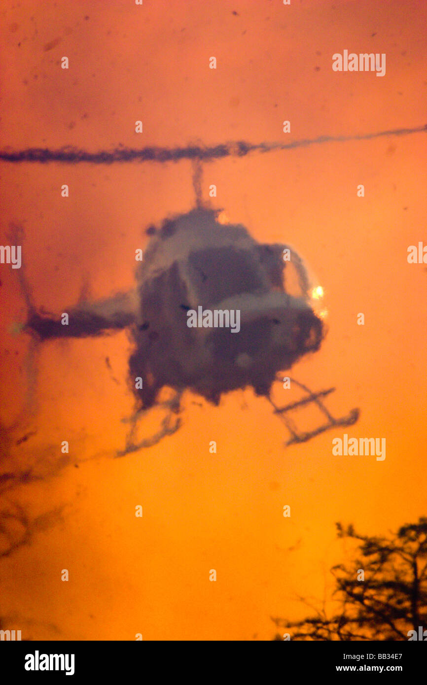 Making a low pass over a forest fire, a Bell Jet Ranger helicopter ...