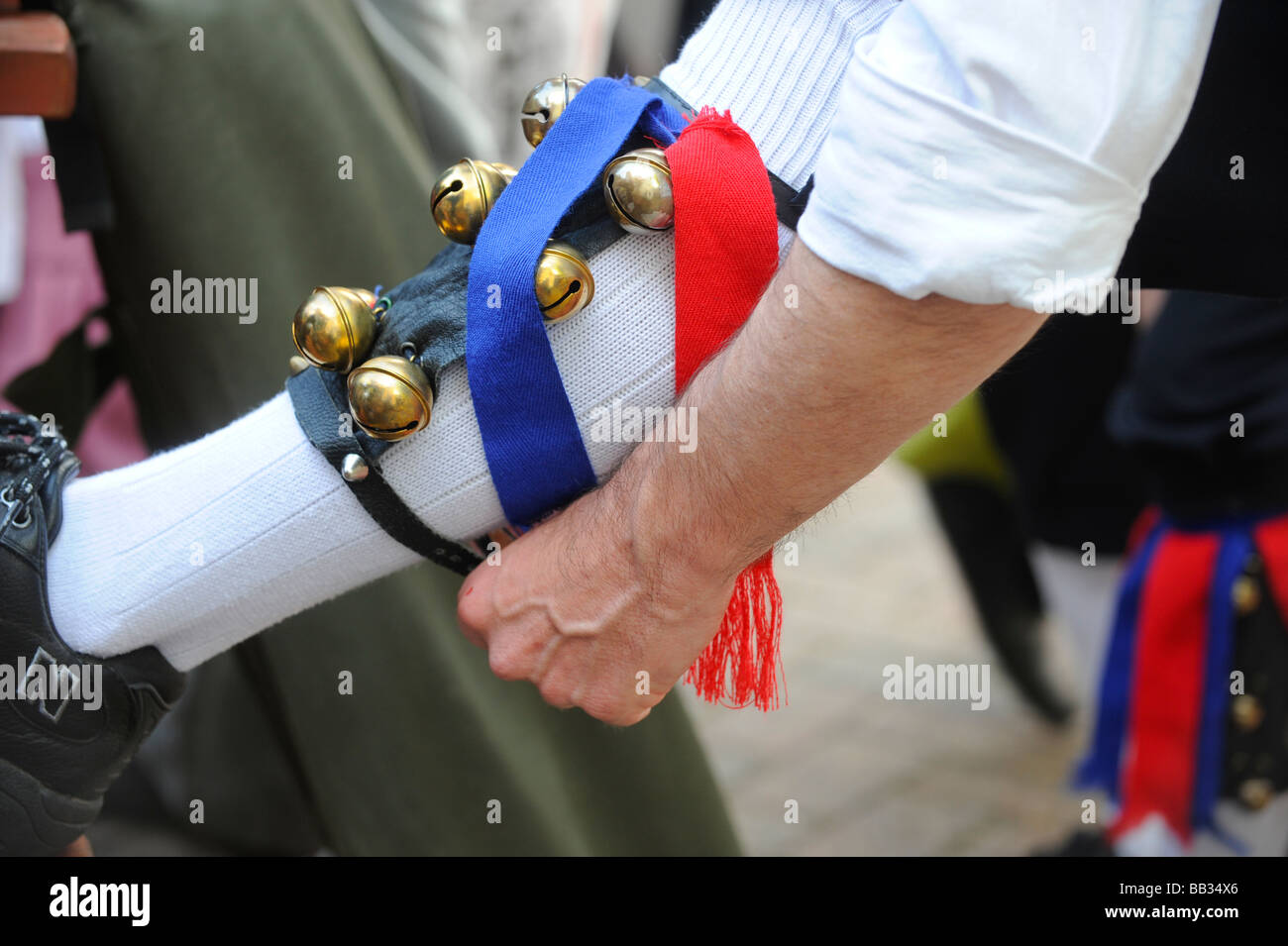 A morris man attaches his bells to his legs before dancing in the ...