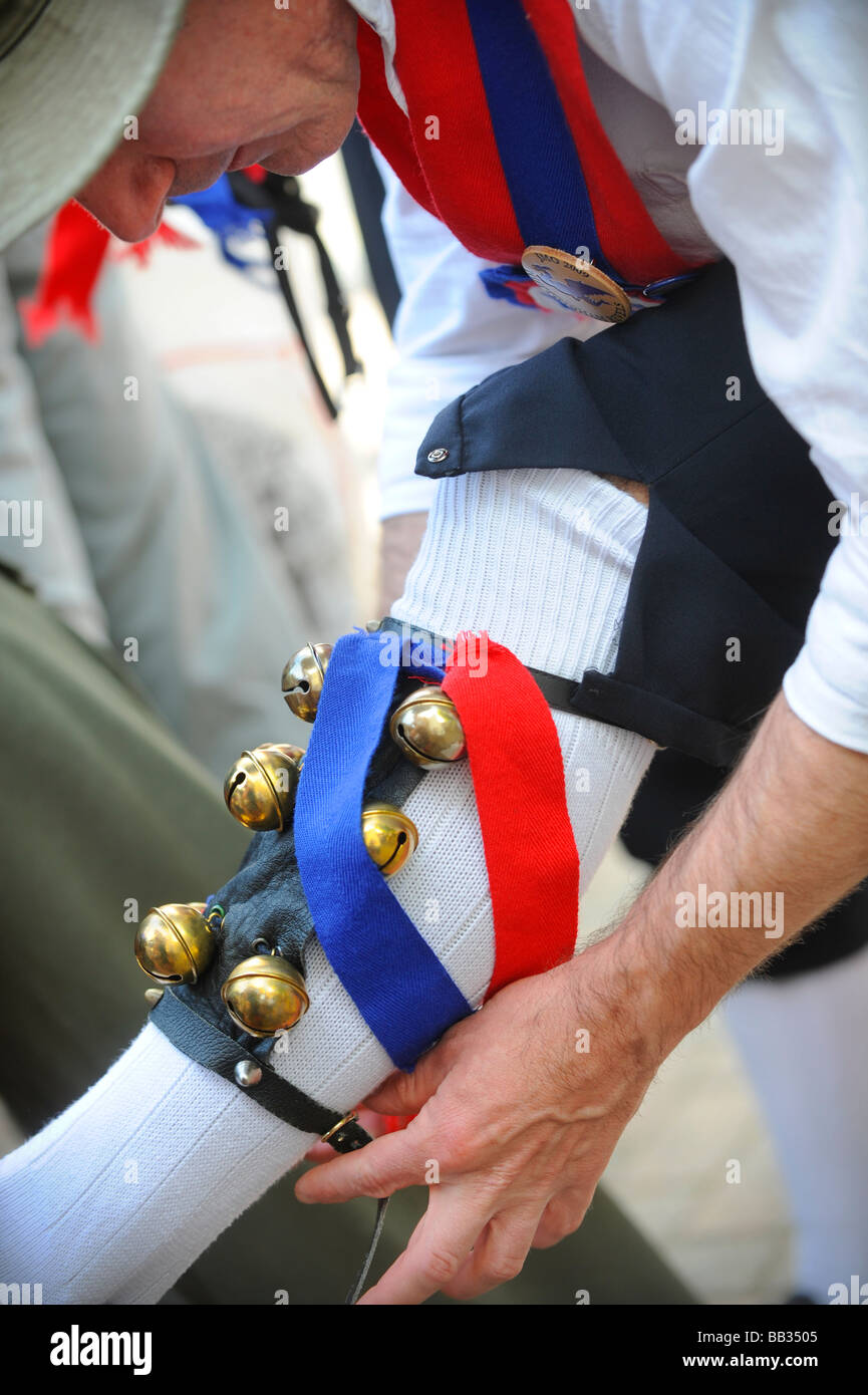 A morris man attaches his bells to his legs before dancing in the ...