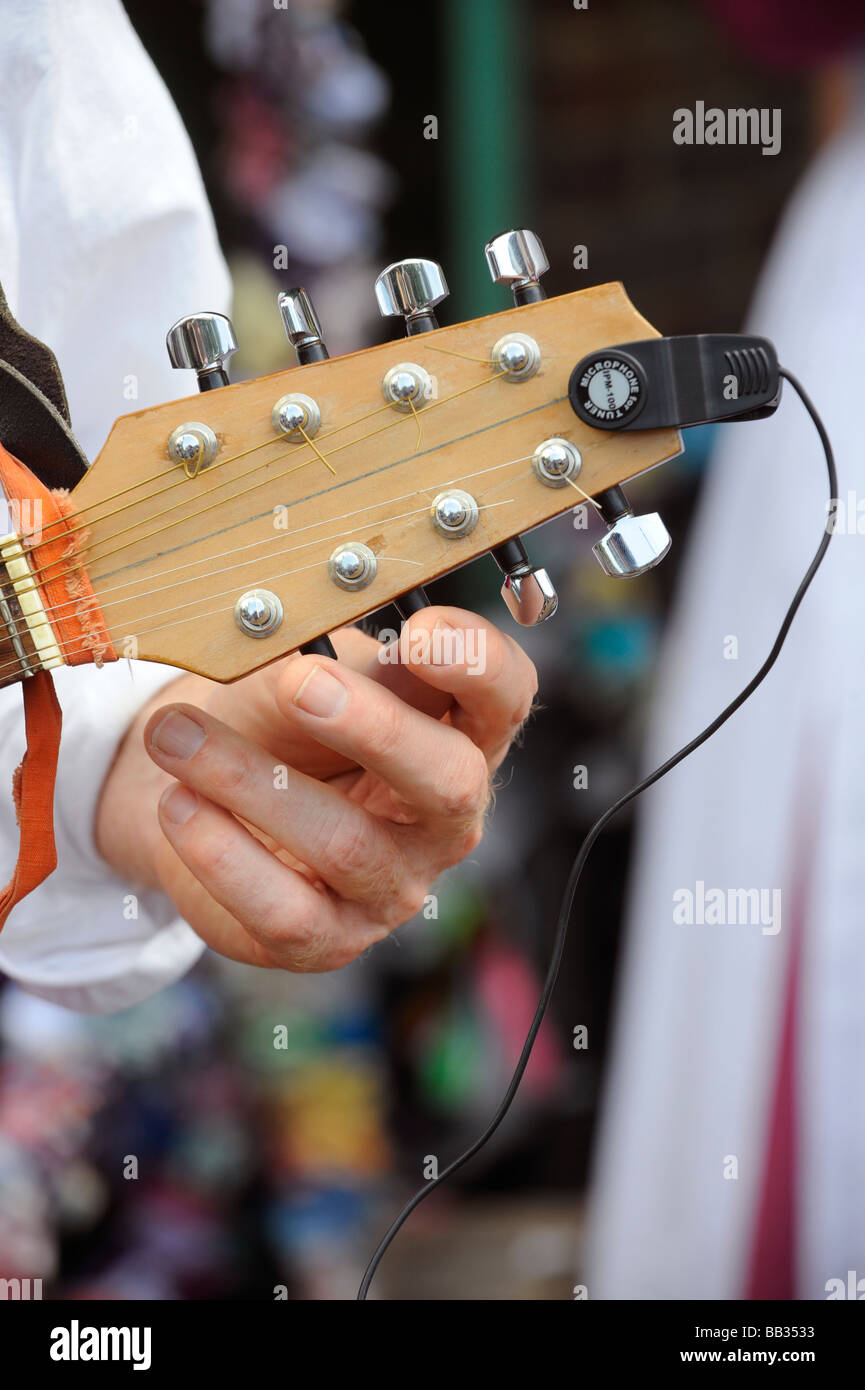 A musician tuning a mandolin. Picture by Jim Holden Stock Photo - Alamy