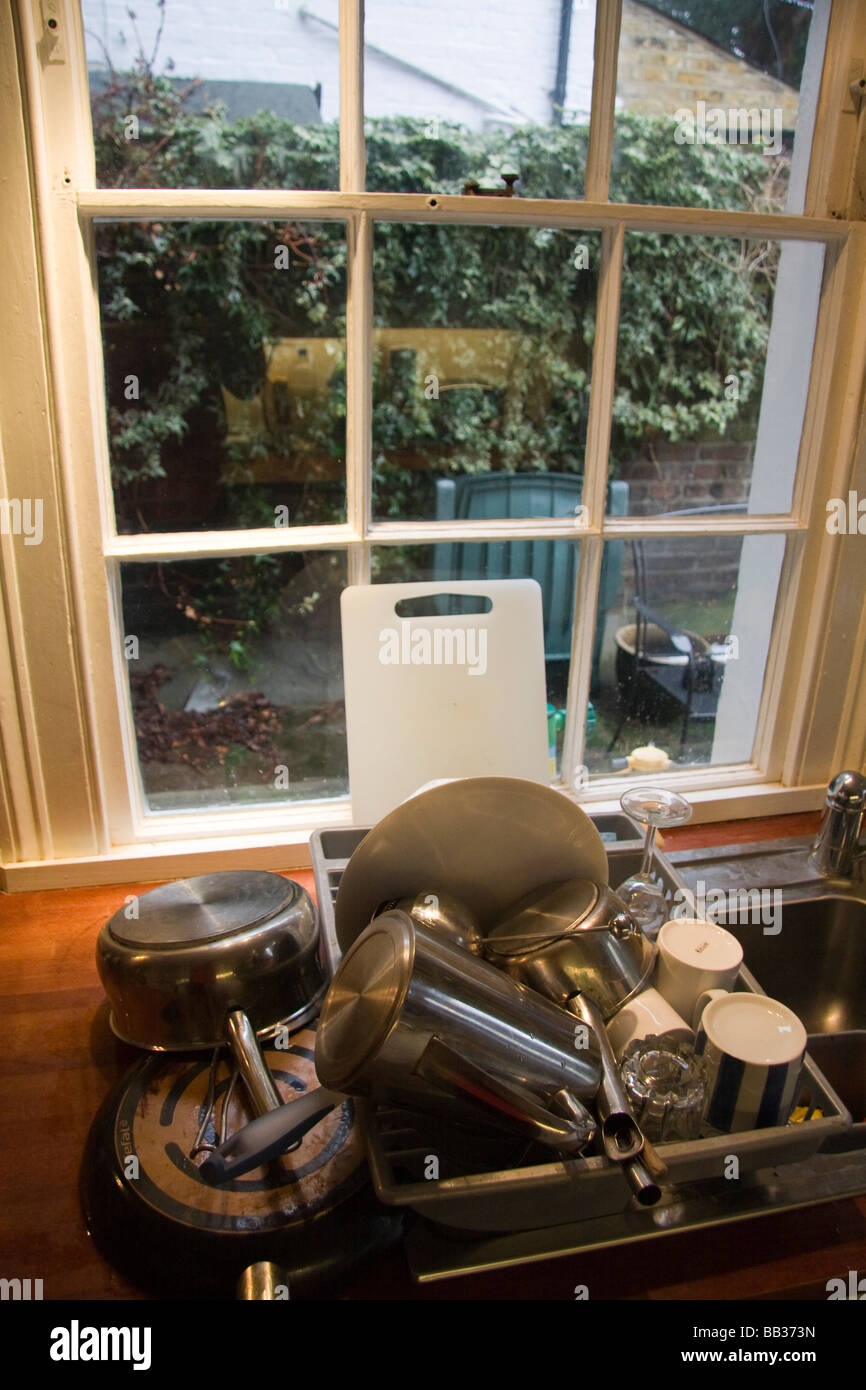 Washing up drying on a drainer by a sash window in Hackney, London ...