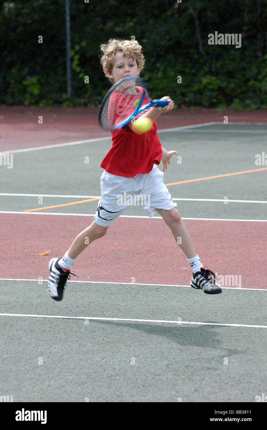 A young boy playing tennis Stock Photo - Alamy