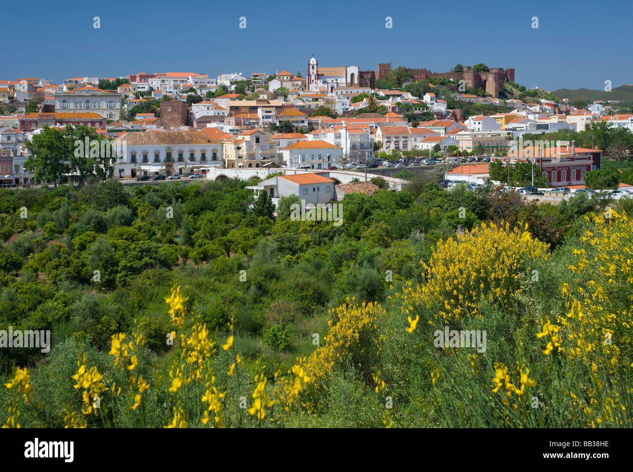 Portugal, the Algarve, Silves town and castle seen over orange groves ...