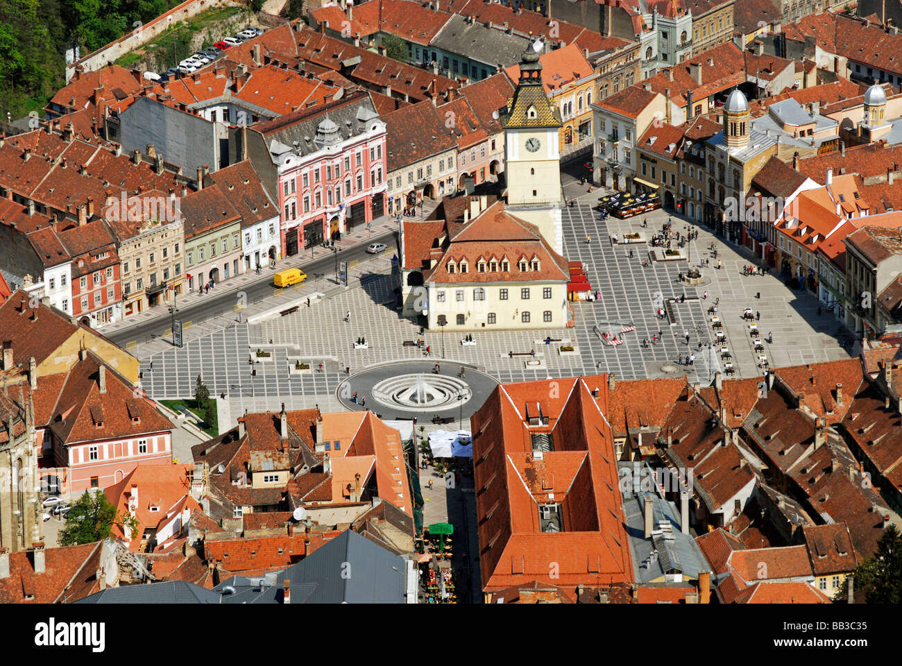 ROMANIA, Brasov. Central main town square with a small white church ...