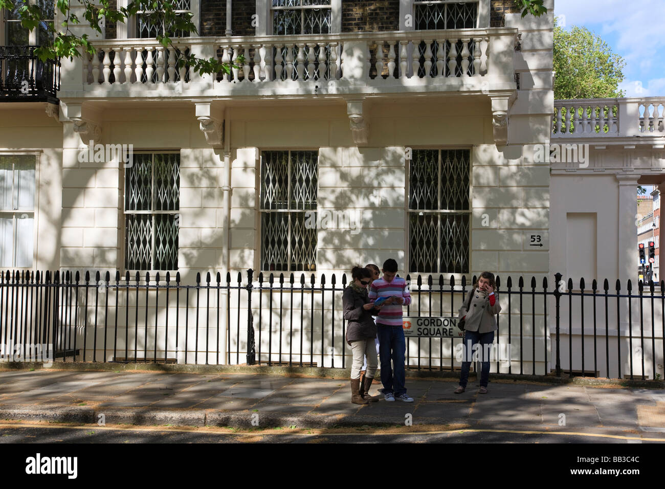 Four visiting students look at a map to find their way on Gordon Square ...