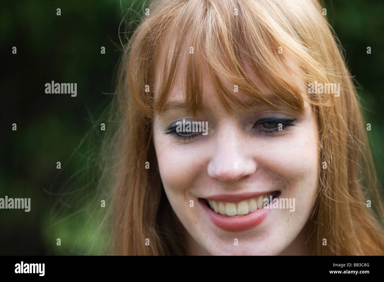 Red haired woman smiling Stock Photo - Alamy