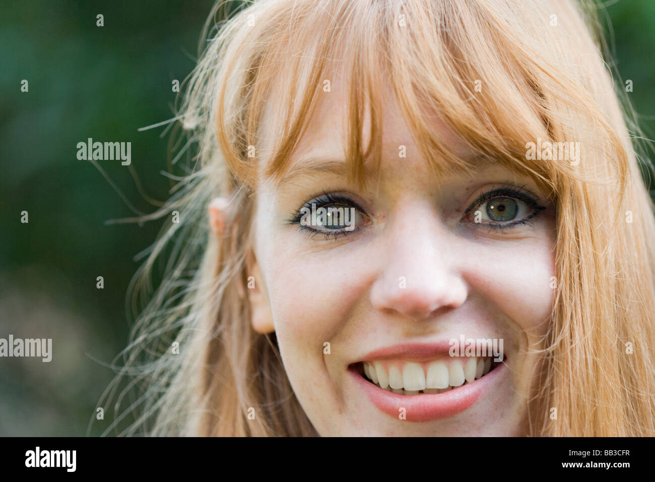 Red haired woman smiling Stock Photo - Alamy
