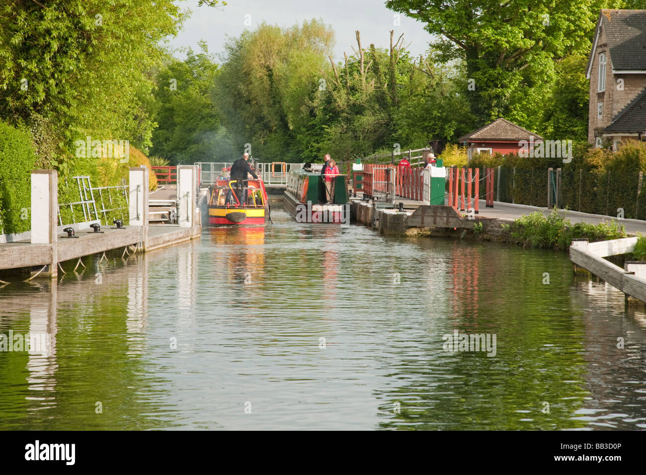 Narrowboats negotiating Osney Lock on the River Thames in Oxford Uk ...