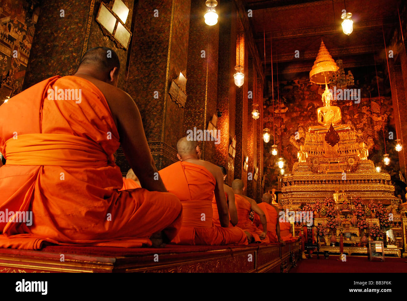 THAILAND, Bangkok. Group of buddhist monks praying in their traditional ...